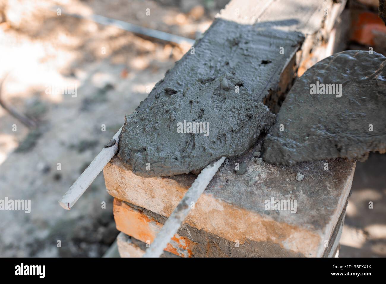 application of wet cement on brick structure showing texture and ...