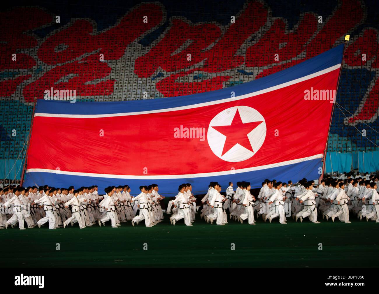 North Korean taekwondo team in front of a giant flag during the Arirang ...