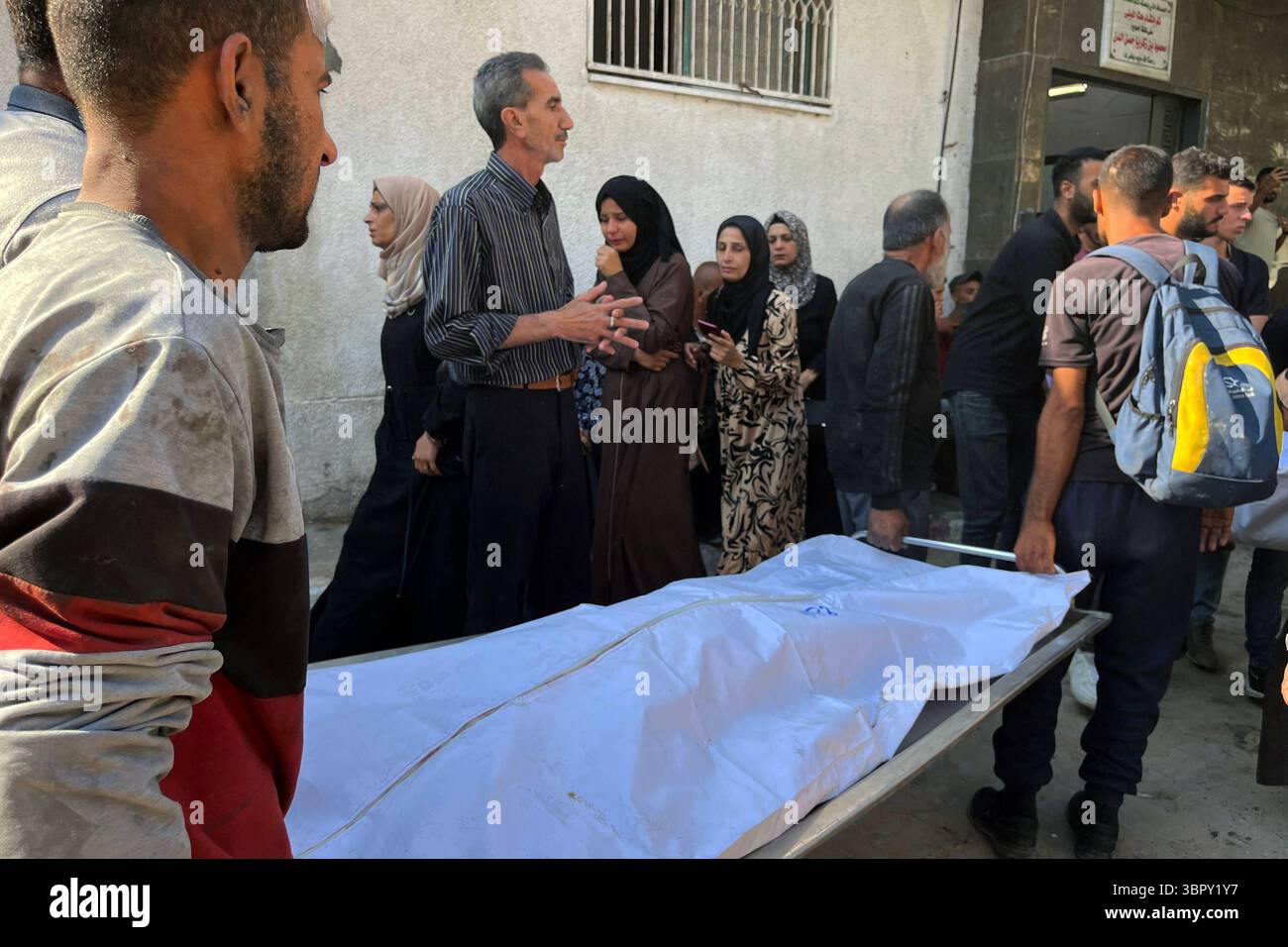 Relatives of Palestinians killed in an Israeli airstrike mourn at the ...
