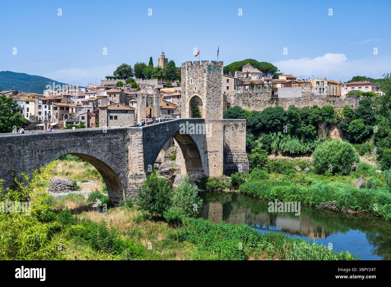 Town and 12th-century Romanesque bridge over the Fluvia river from main ...