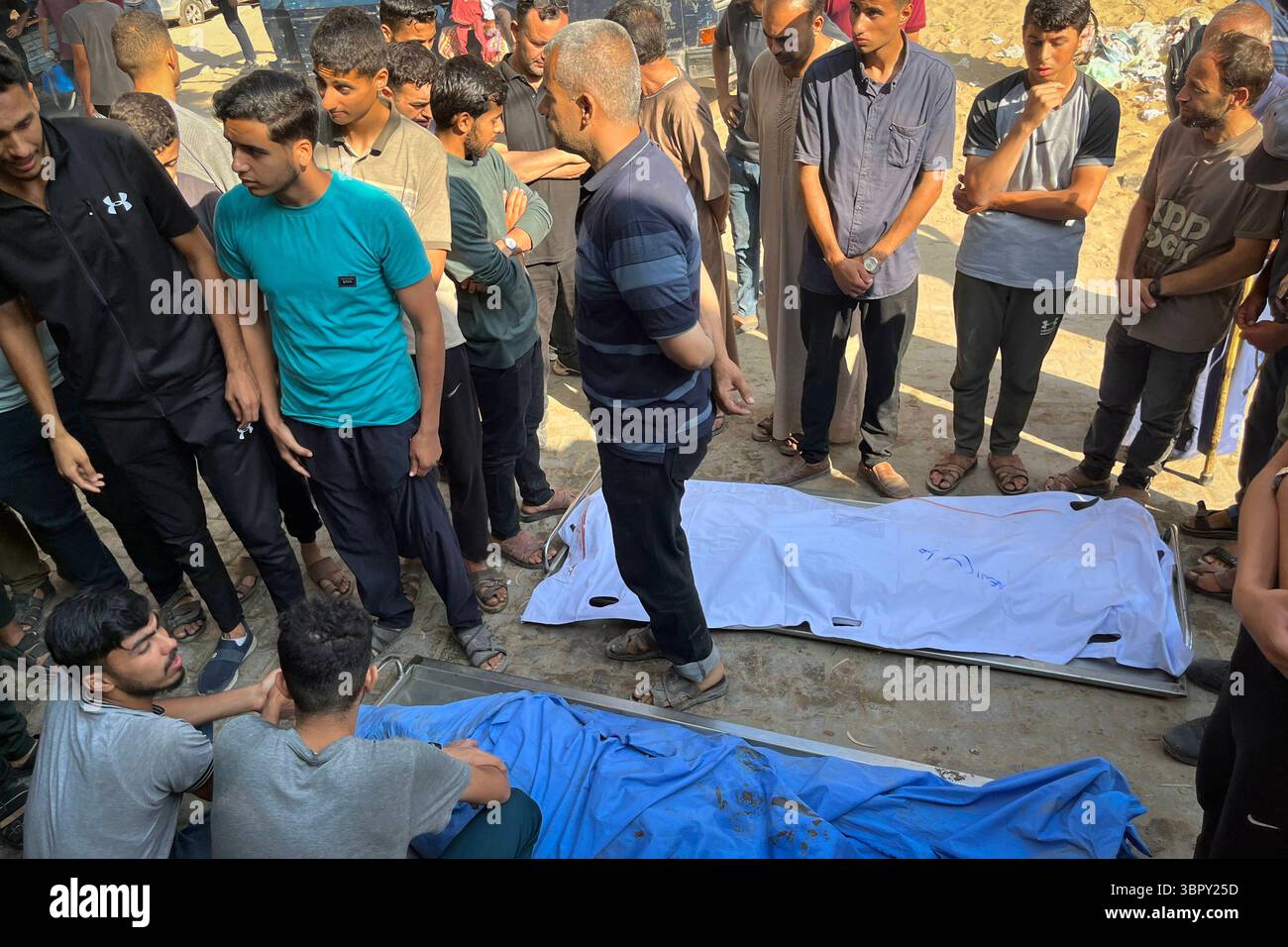 Relatives of Palestinians killed in an Israeli airstrike mourn at the ...