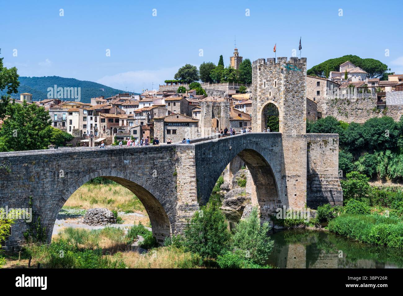 Town and 12th-century Romanesque bridge over the Fluvia river from main ...