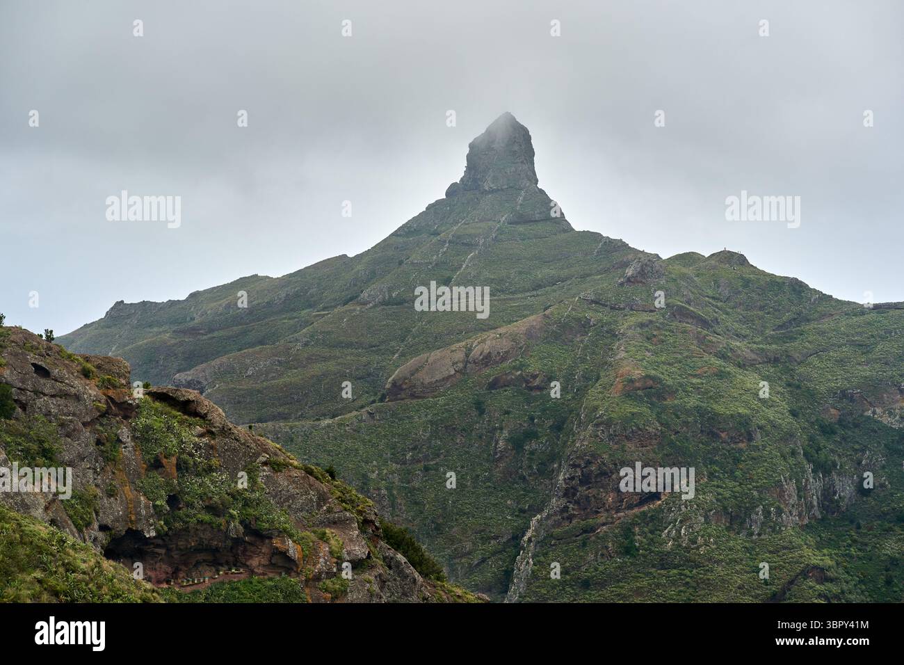 Roque de Taborno and hillside cave with traditional beehives visible in ...
