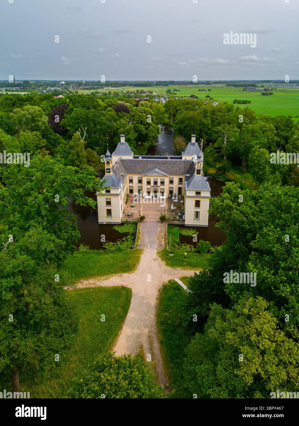 Aerial view of a historic castle surrounded by a forest, with vast ...