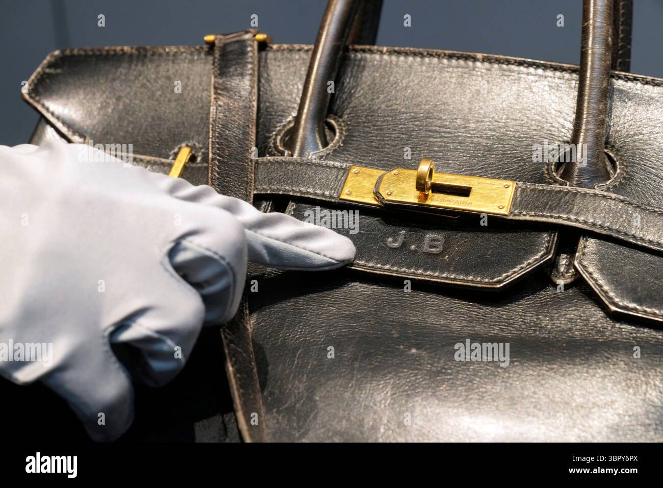 An auction officer points to Jane Birkin's initials on the original ...