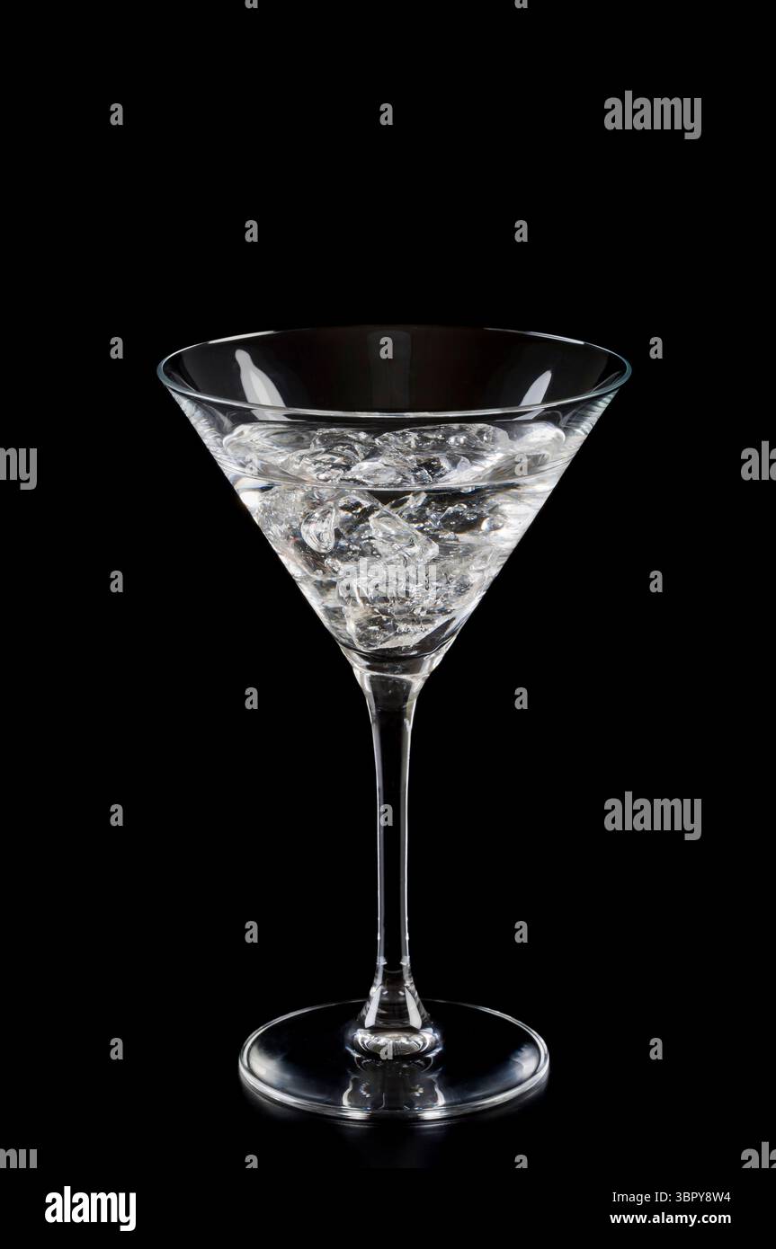 Chilled dry martini with ice in martini glass on black Stock Photo - Alamy