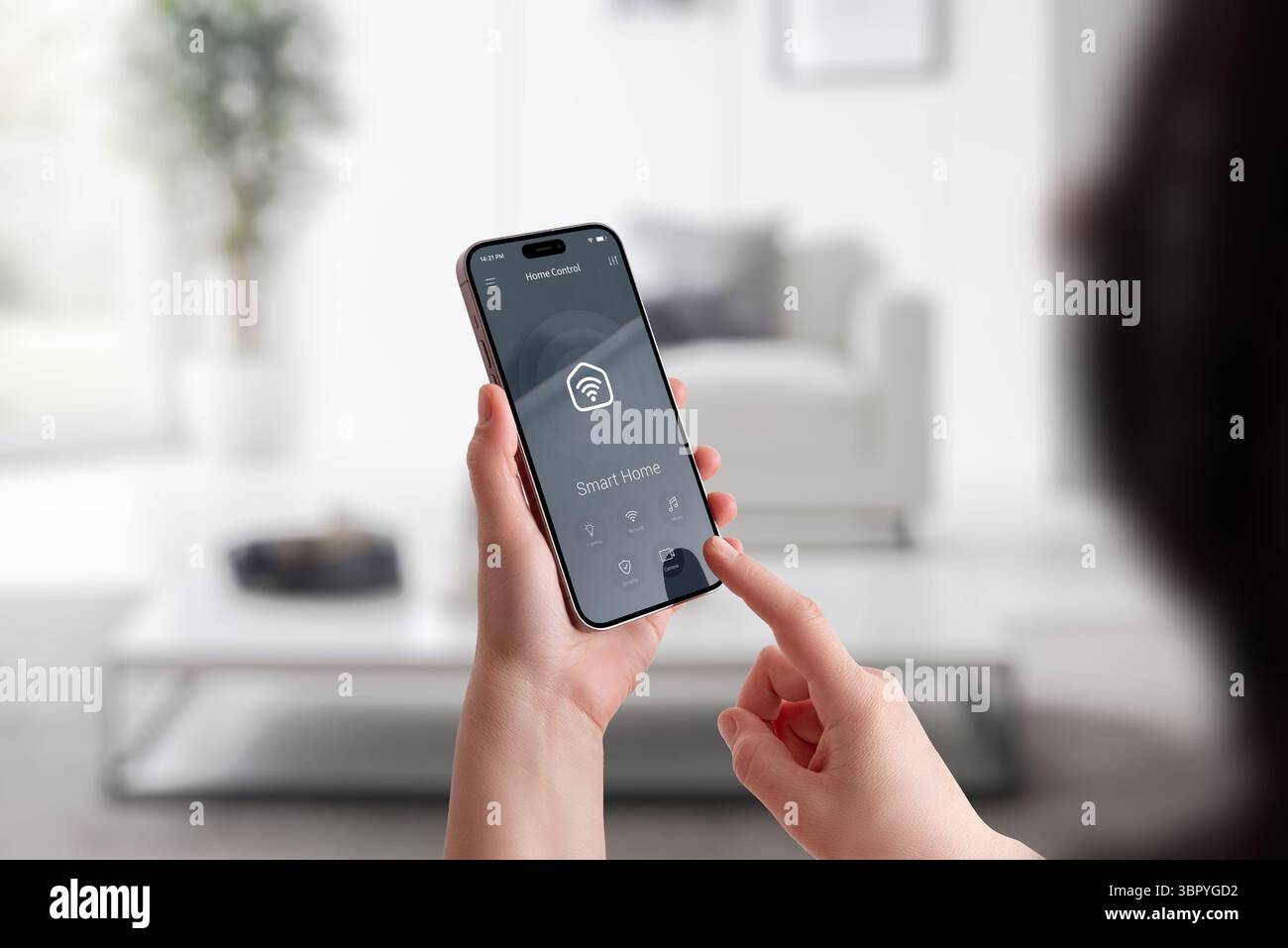 Woman interacting with smart home interface on mobile phone in modern ...