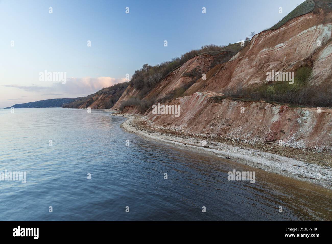 Rocky, pebble and clayey banks of the Kama River. Mountain slope of ...