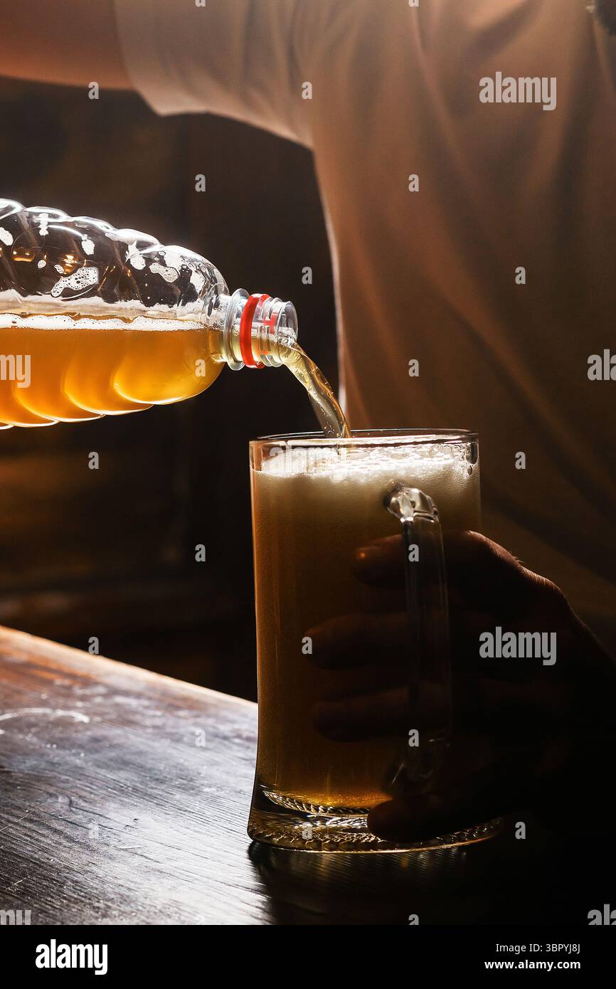 Pouring dark light beer plastic hi-res stock photography and images - Alamy