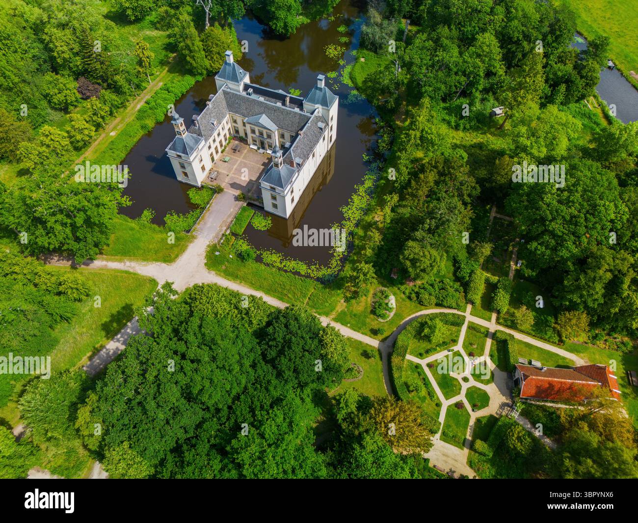 Aerial view of a historic castle surrounded by a forest, with vast ...