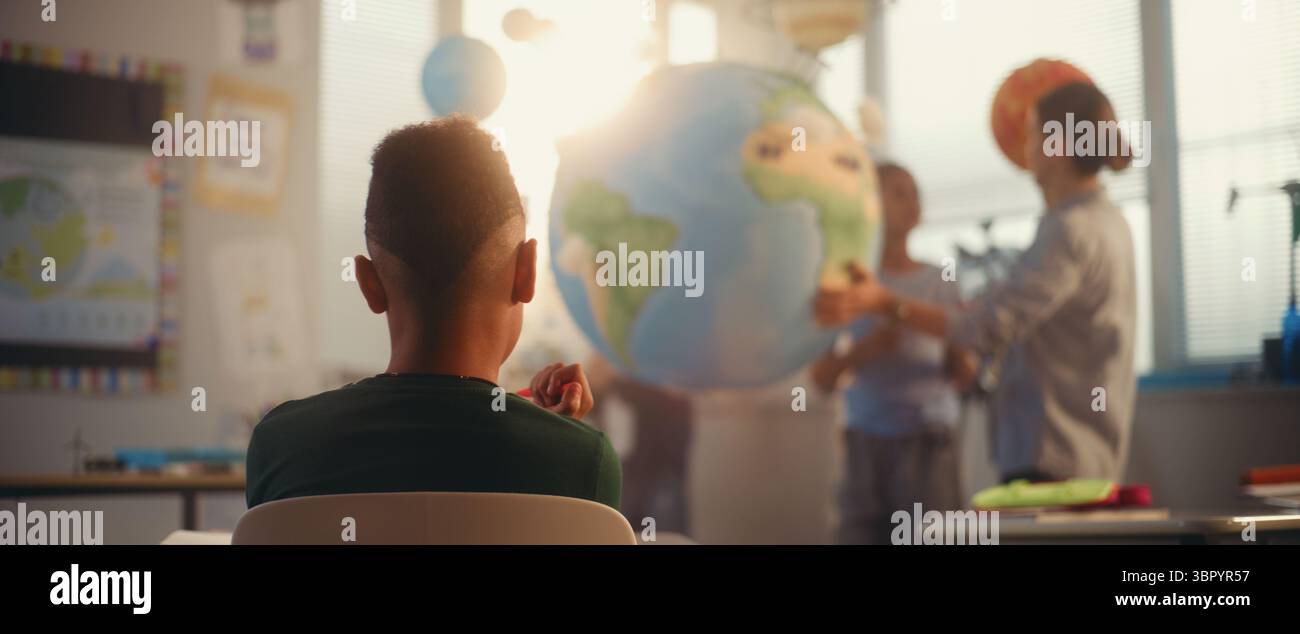STEM Class on Renewable Energy: Female Teacher Explaining Energy Resources to Elementary School ...