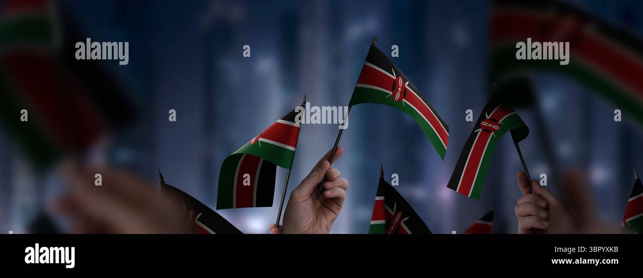 Kenya flags in their hands on a blurred urban background Stock Photo ...
