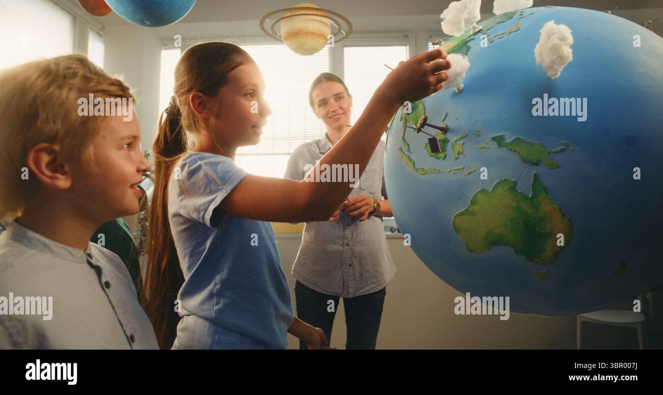 STEM Class: Talented Girl Presenting Green Energy Sources Using Earth ...
