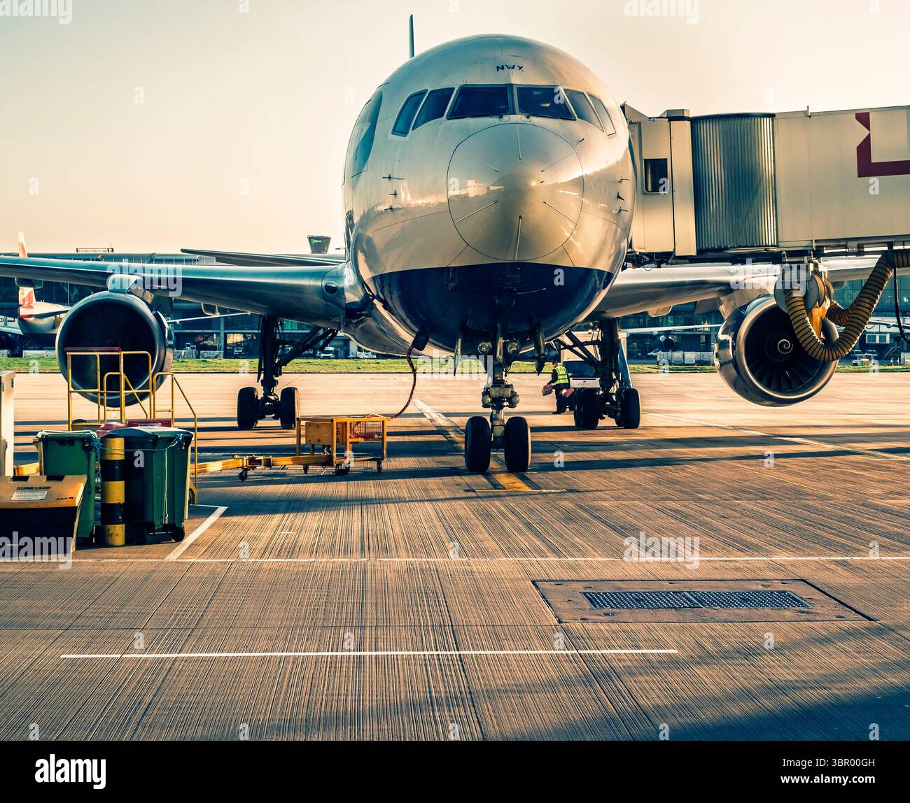 Front view of landed airplane in a terminal of Heathrow airport; London ...
