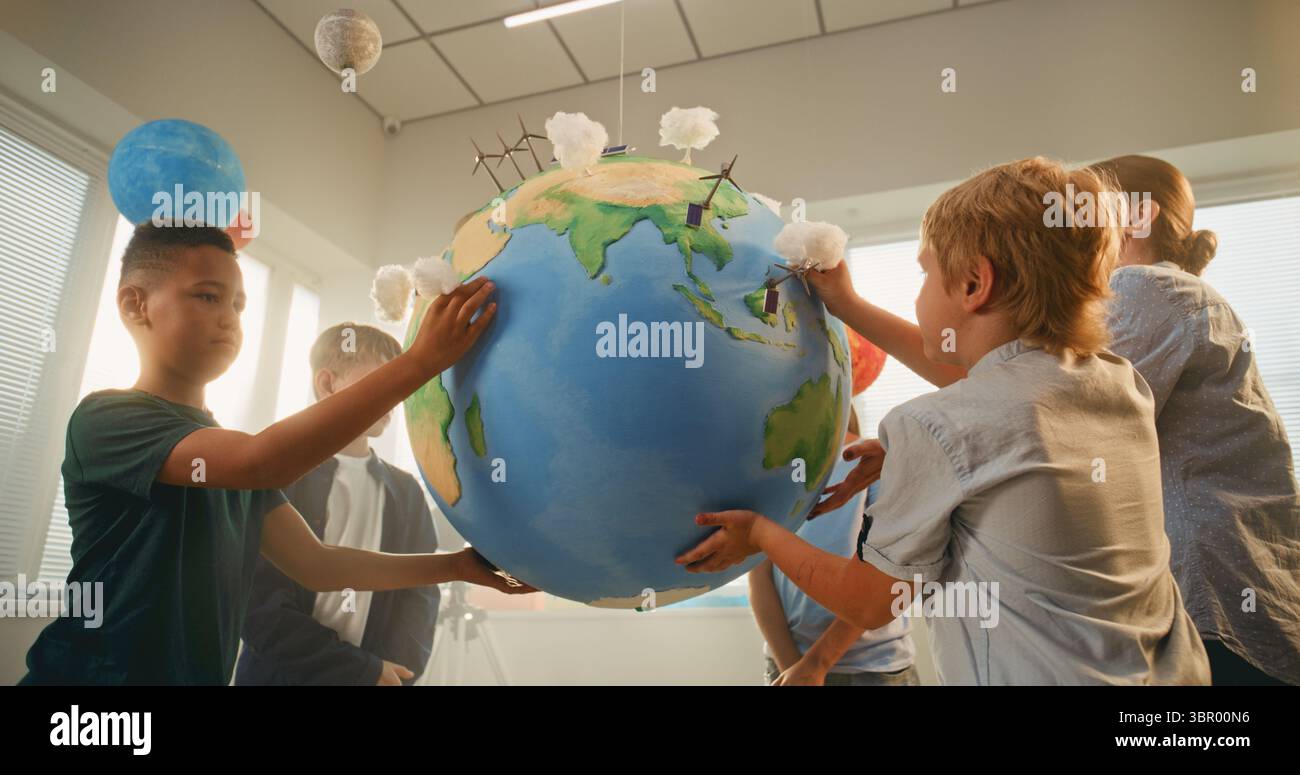 Science Lesson: Female Teacher Educating Renewable Energy to Smart Kids ...