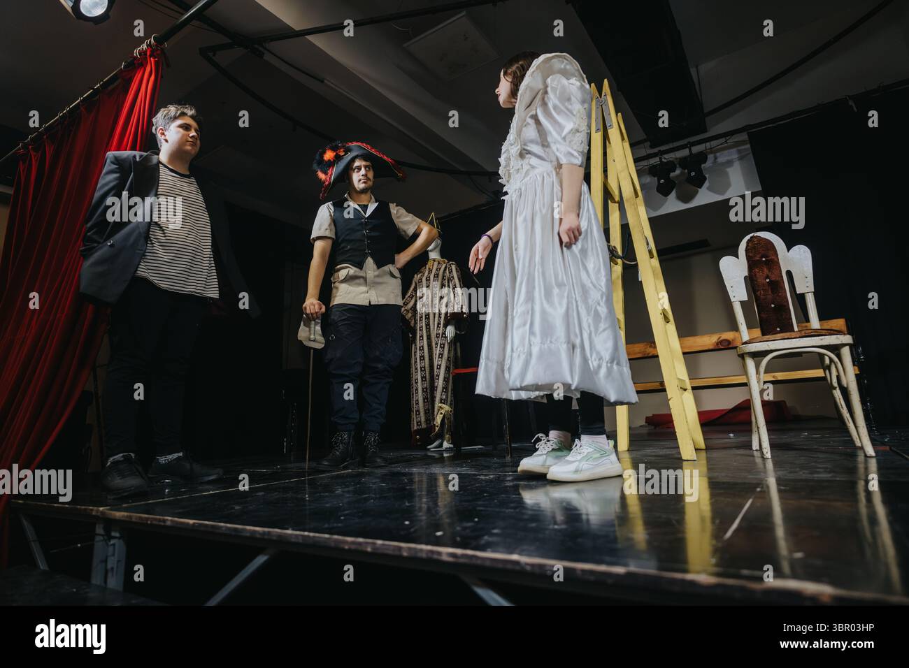 Young actors performing a dramatic play with costumes on stage Stock ...