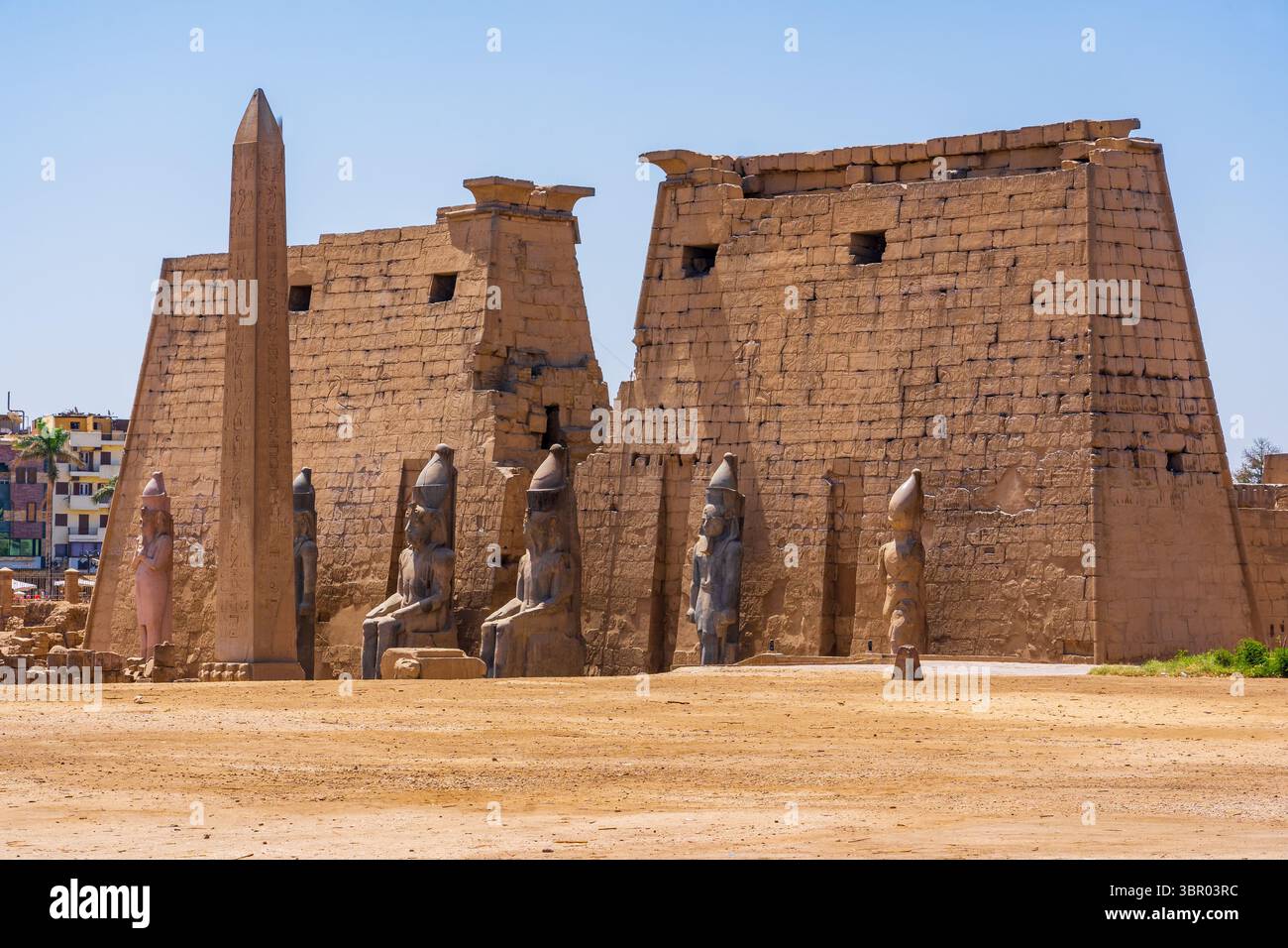 View of the Luxor Temple first pylon with massive statue of Ramesses II ...