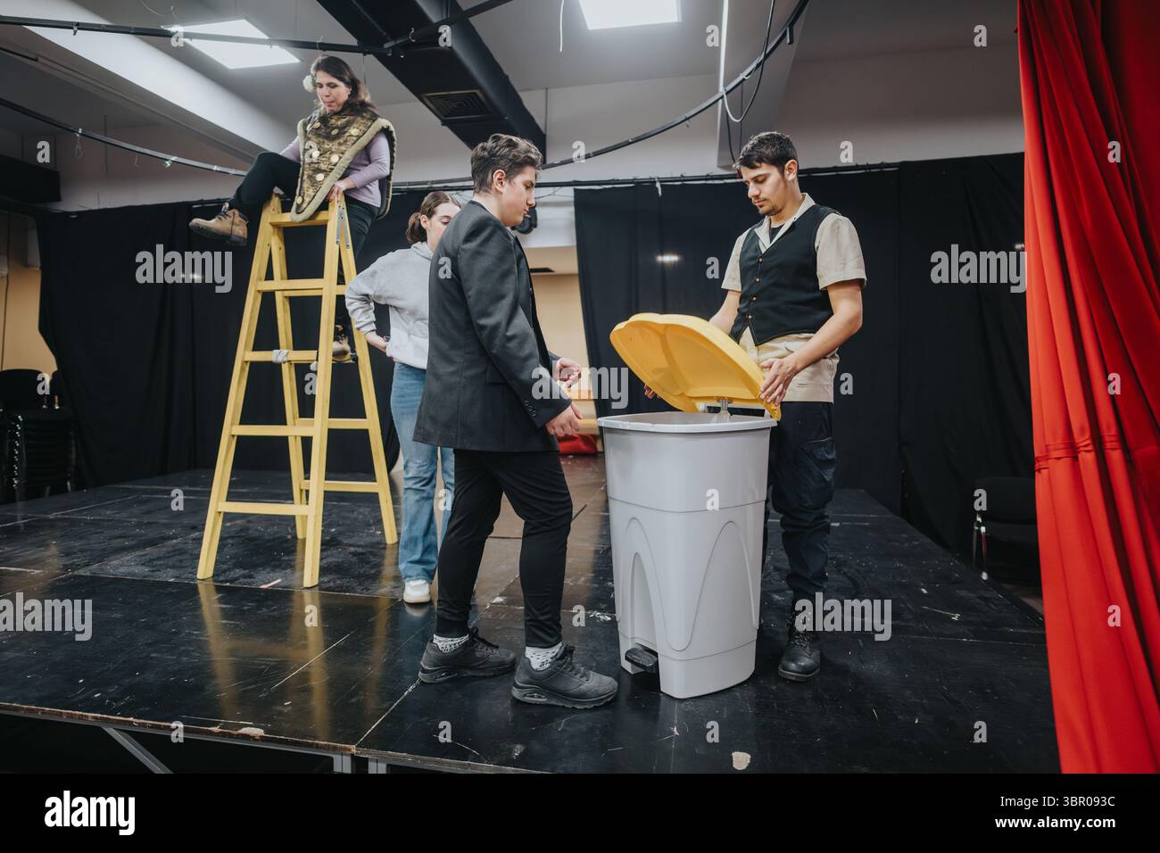 Young actors rehearsing on a stage with lively dialogue Stock Photo - Alamy