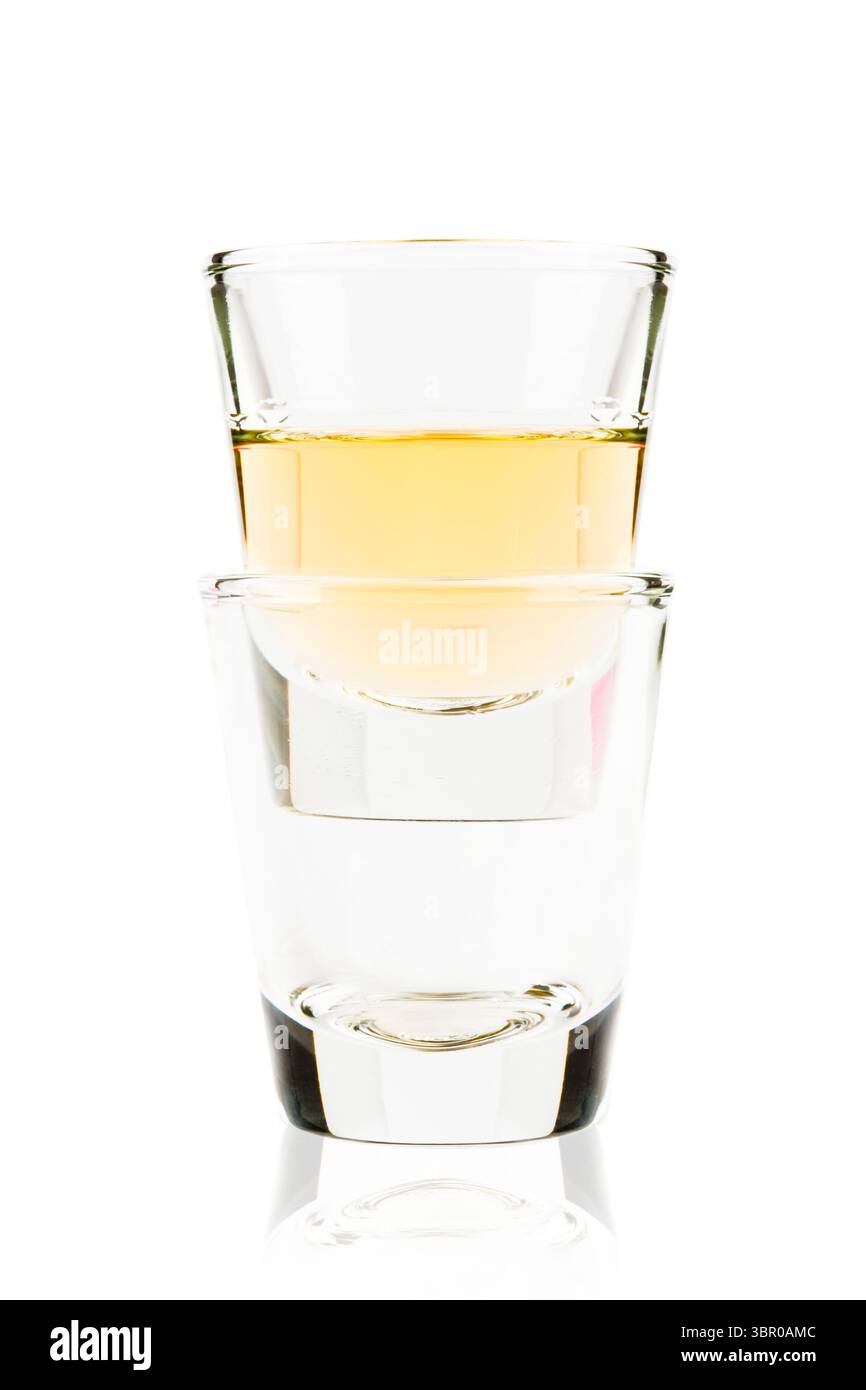 two tequila shots on top of each other isolated on white background ...