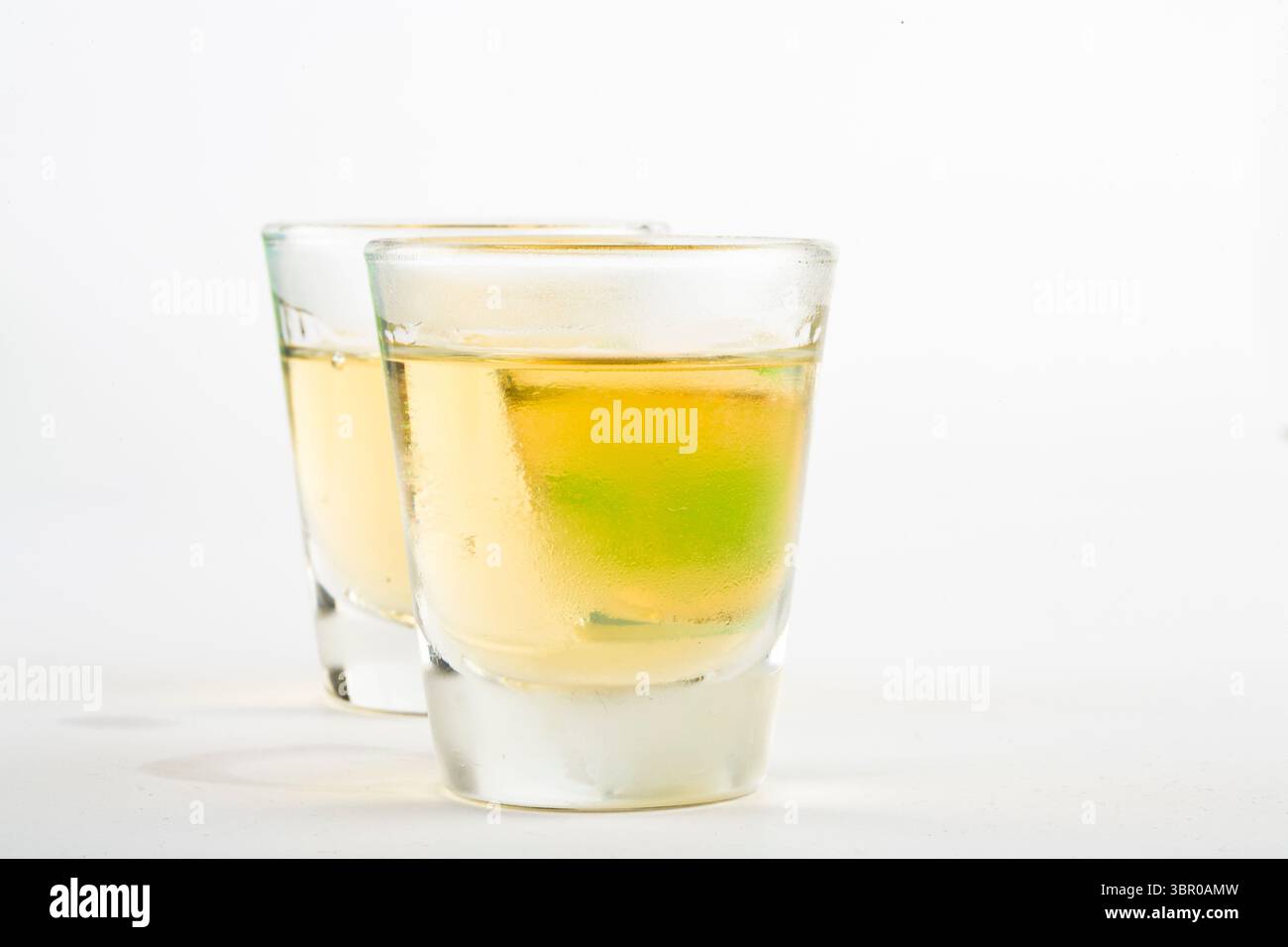 tequila in two shot glasses isolated on white background Stock Photo ...
