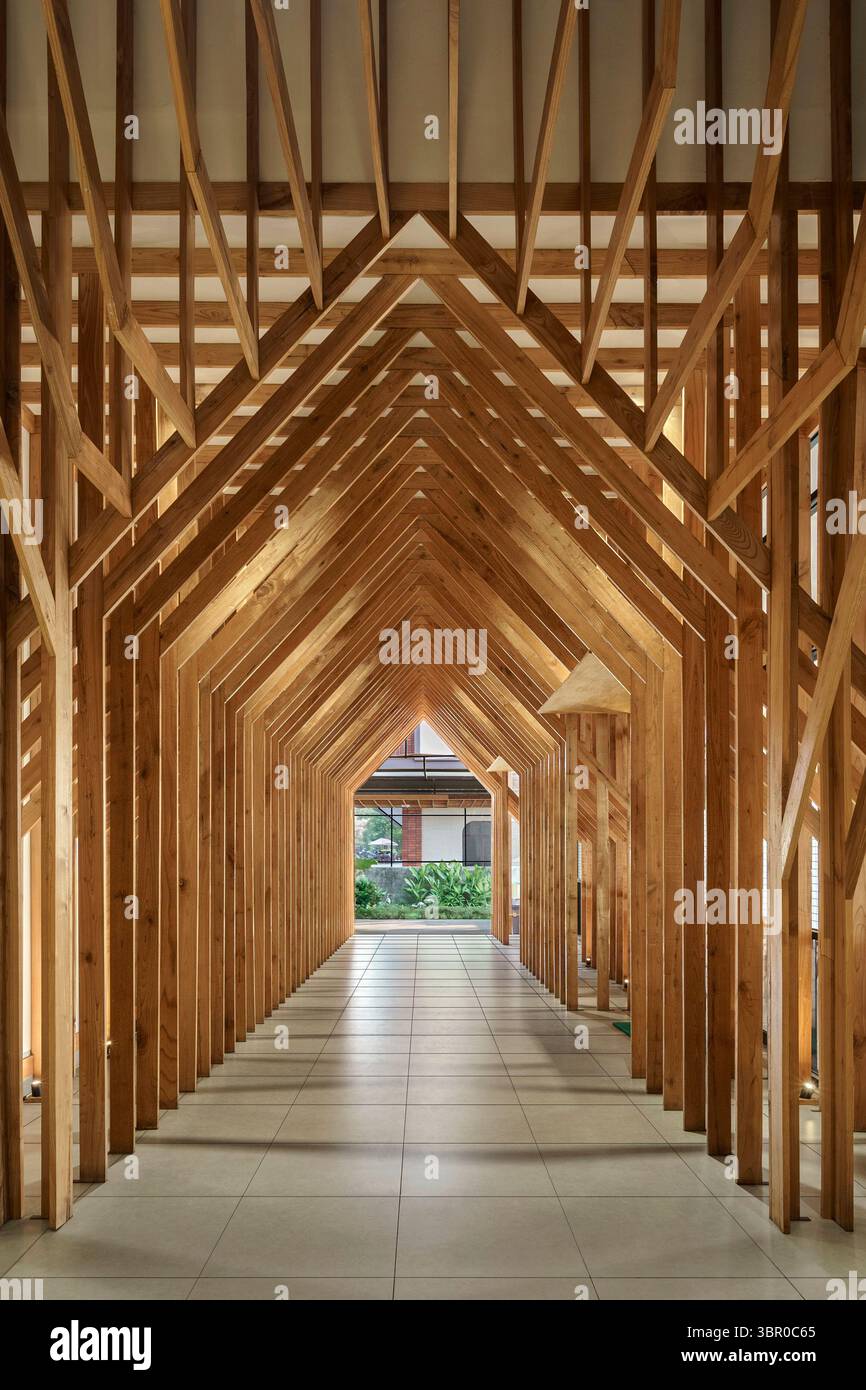 Symmetrical view down a long architectural corridor with a repeating ...