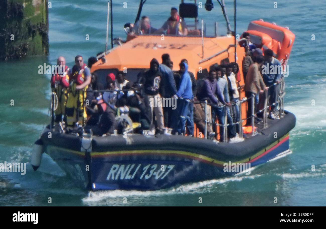 A group of people thought to be migrants are brought in to Dover, Kent ...