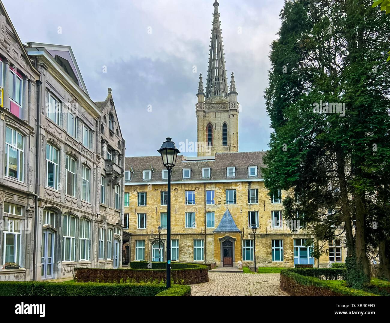 Grand university building in Leuven with gothic tower surrounded by ...