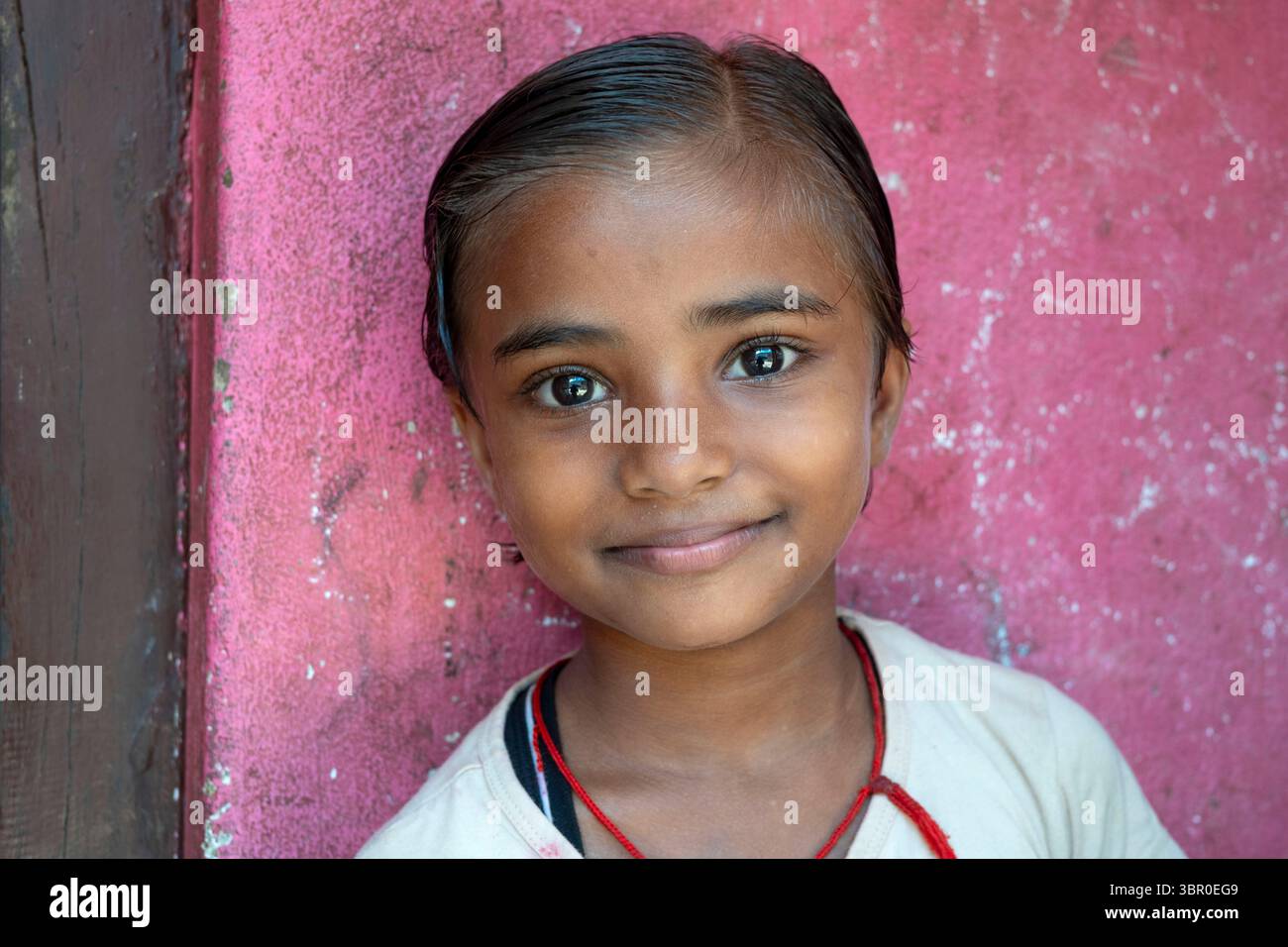 Young girl outside workshop in town known for skilled ikat weaving ...