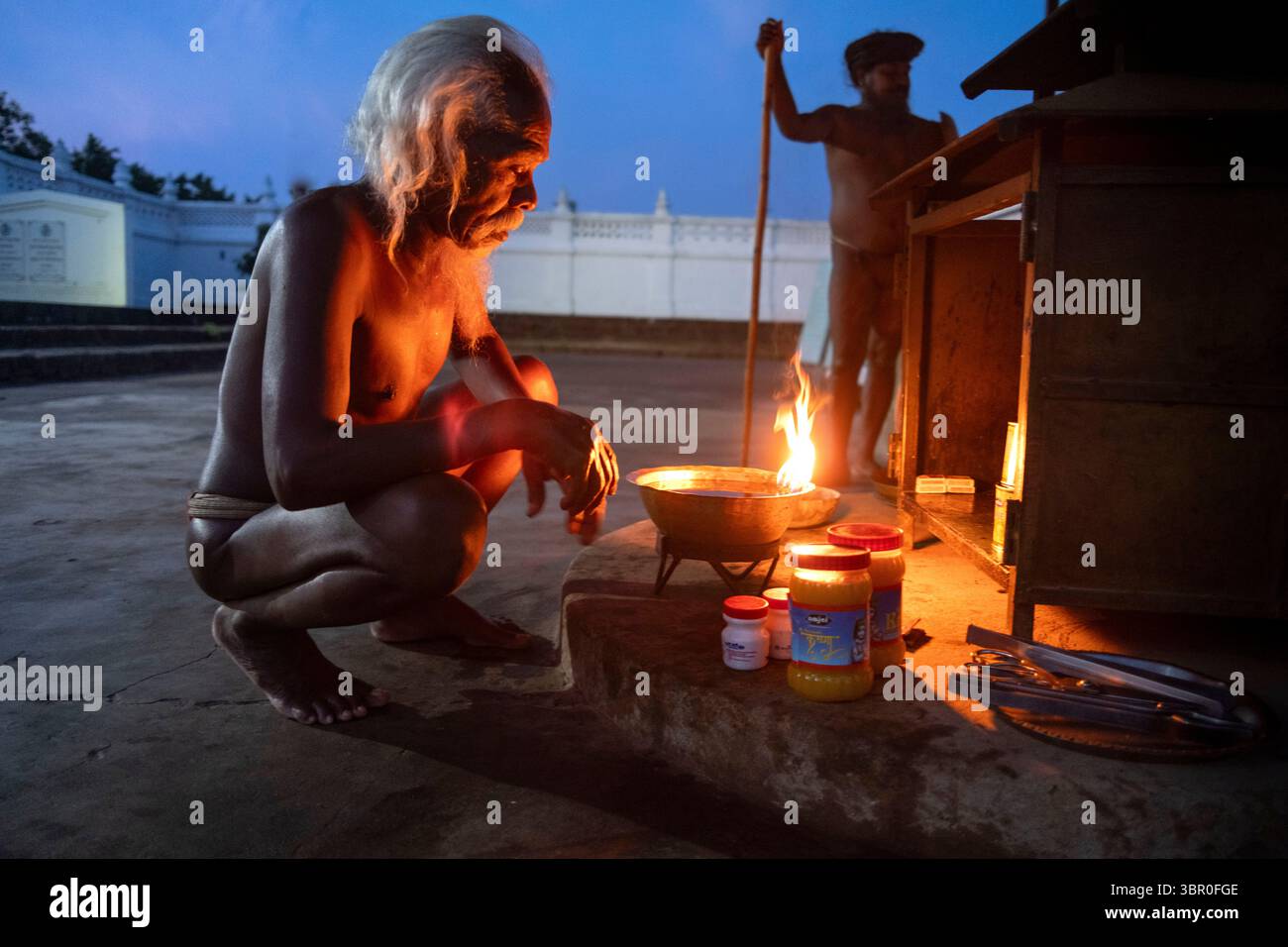 Monk of the Mahima Dharma Hindu sect says prayers and tends holy fire ...