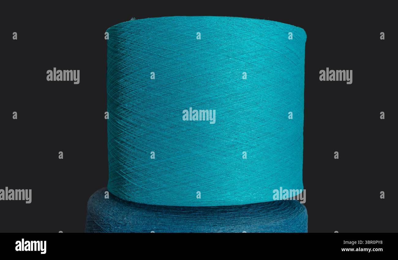 Texture of blue threads wound on spool on dark background. Blue threads ...