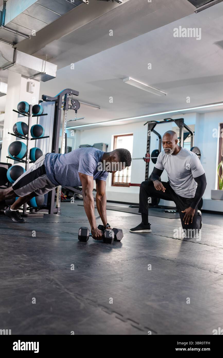 African American trainer and client performing elevated push-ups on hex ...