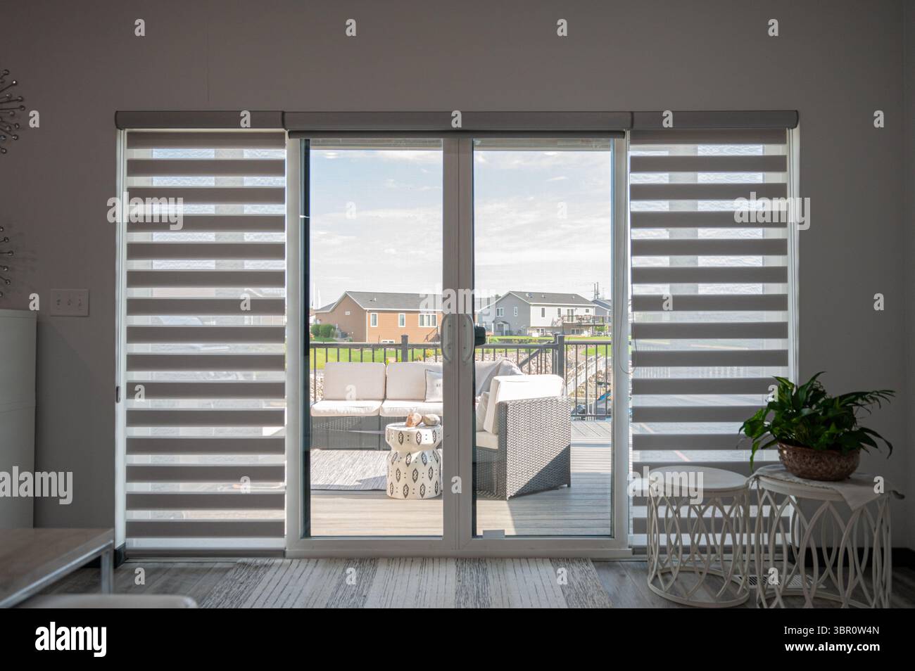 Bright living room with sliding door and view outside Stock Photo - Alamy