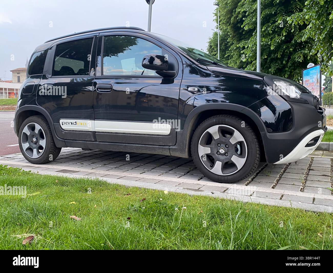 Cremona, Italy June 8th 2025 Compact Fiat Panda Cross 4x4 parking beside urban sidewalk ...
