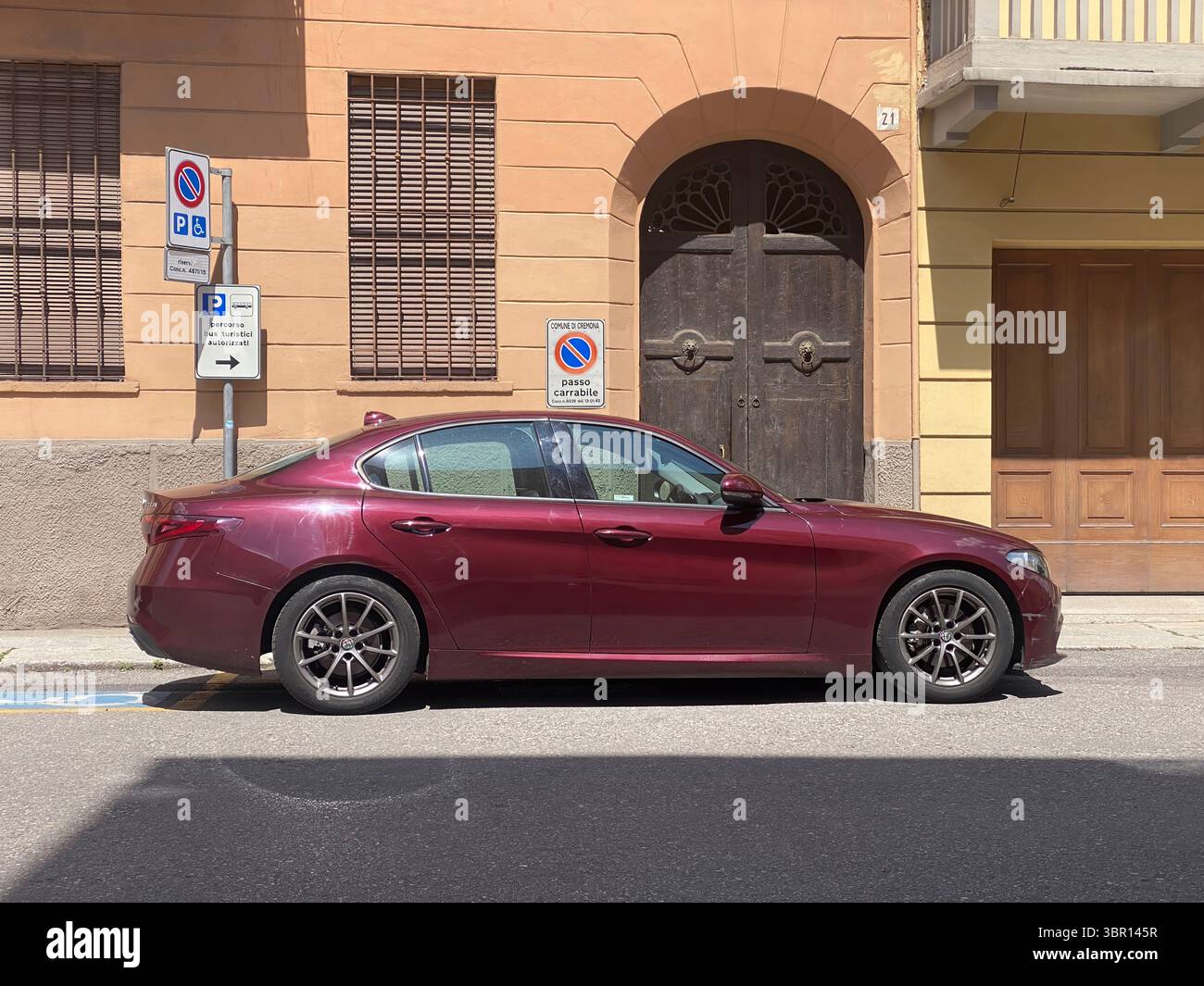 Cremona, Italy June 8th 2025 Red Alfa Romeo Giulia parked beside ...