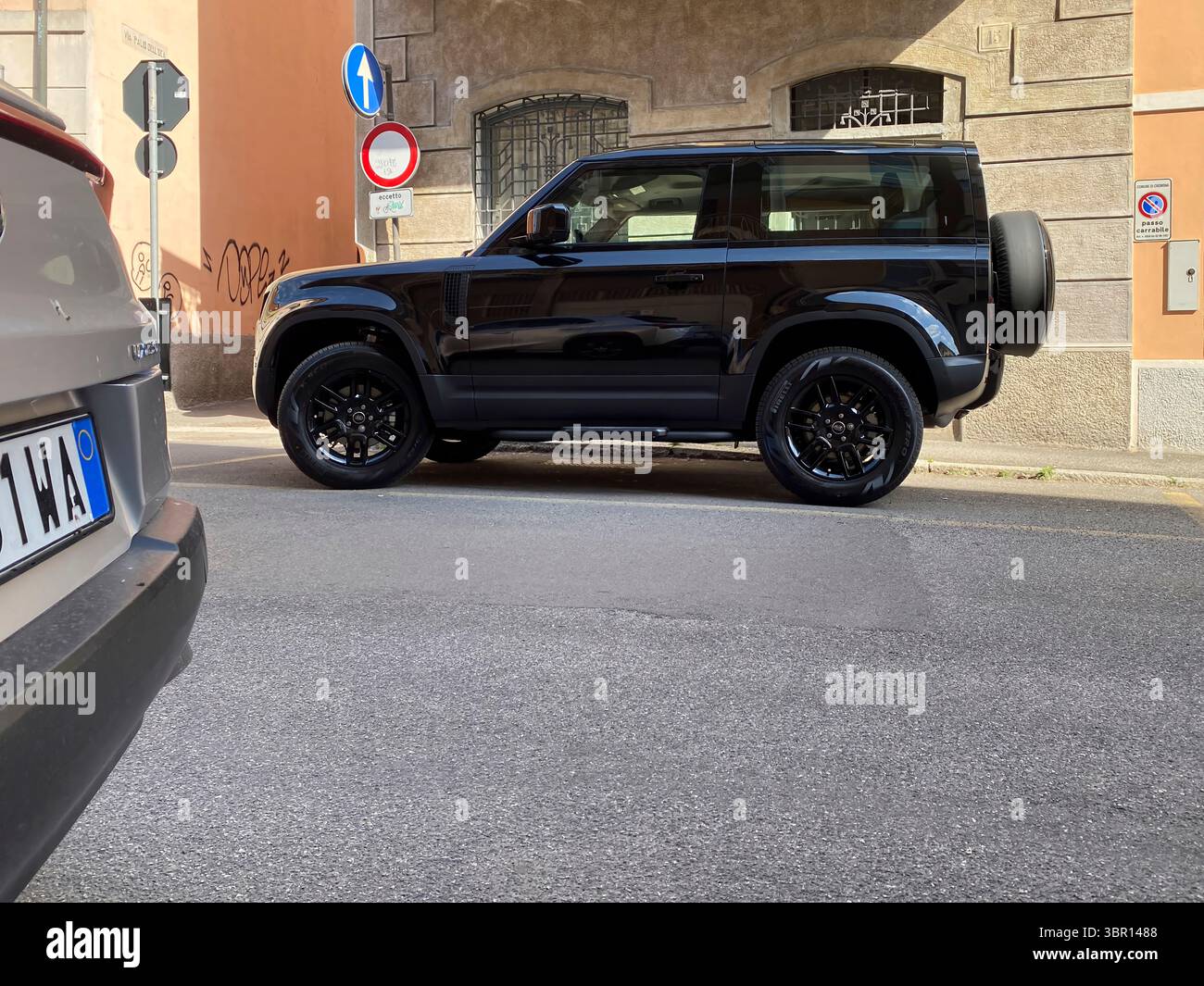 Cremona, Italy June 8th 2025 Shiny black Land Rover Defender 90 parked ...