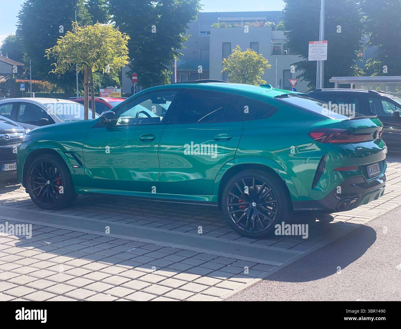 Cremona, Italy June 8th 2025 Shiny green BMW X6 M Competition parked in ...
