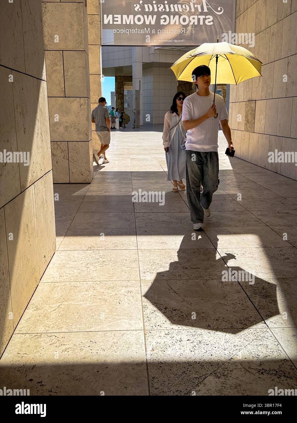 An tourist shields himself from the hot afternoon sun at the Getty ...