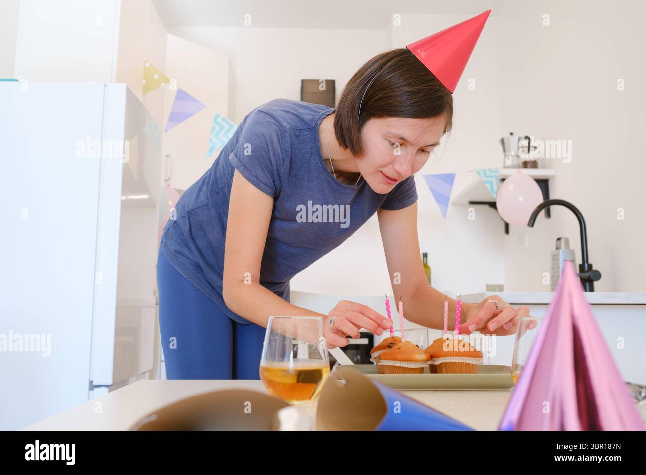 Young woman celebrates her birthday at home, surrounded by cozy ...