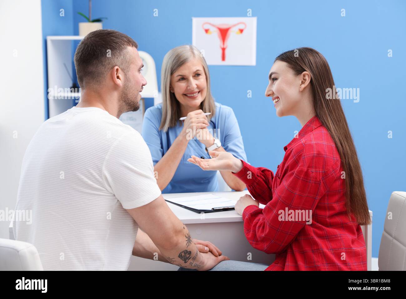 In vitro fertilization (IVF). Couple having consultation with doctor in ...