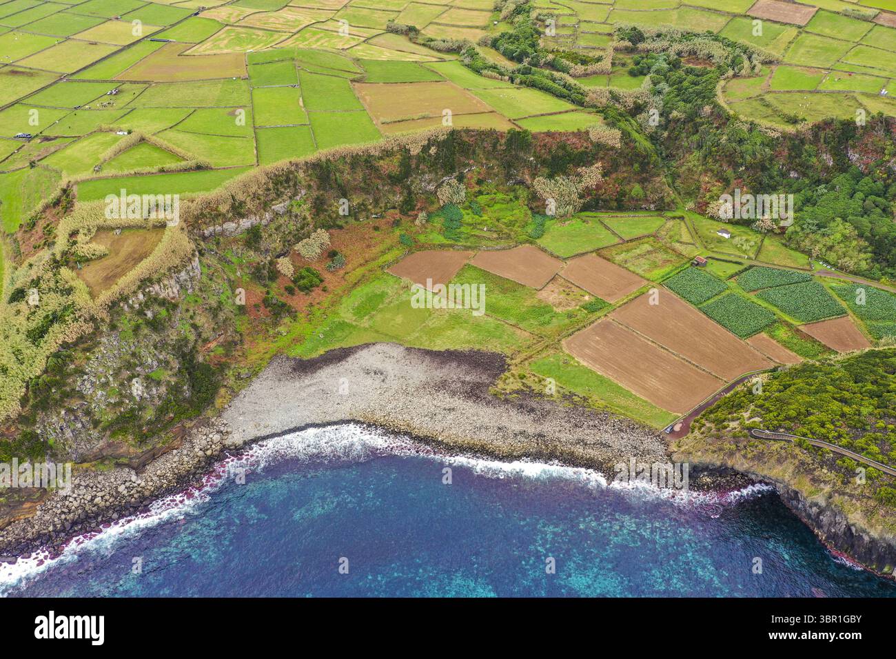 Aerial view of the rugged coastline where the dark blue ocean meets the ...