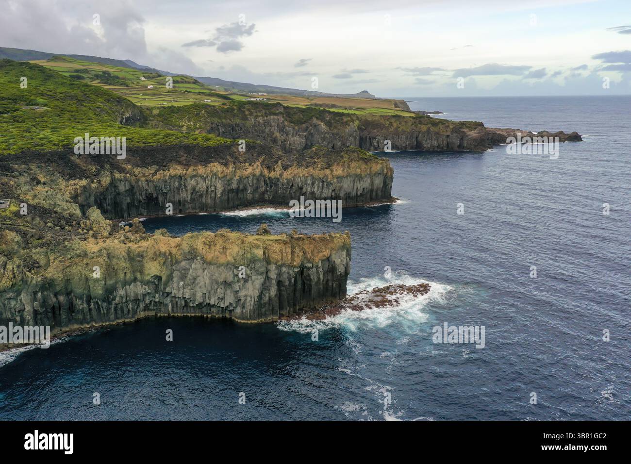 Aerial view of dramatic cliffs plunging into the turbulent Atlantic ...