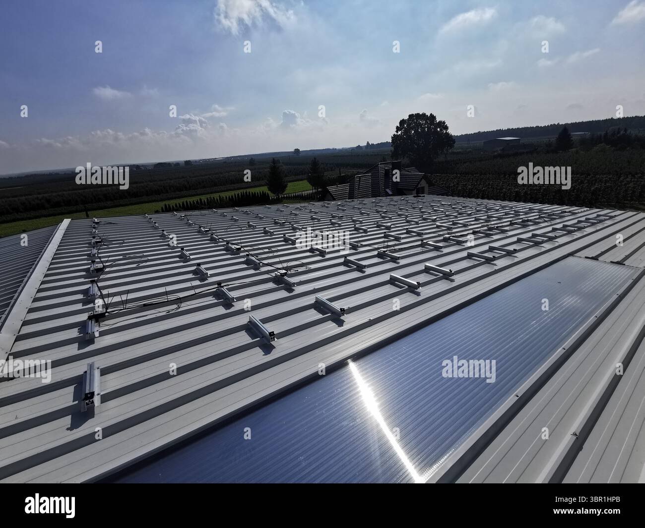 Structure on the house roof for solar panels with installed power optimizers Stock Photo - Alamy