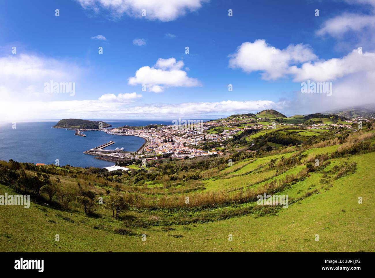 Aerial view of the town nestled between the deep blue sea and verdant ...