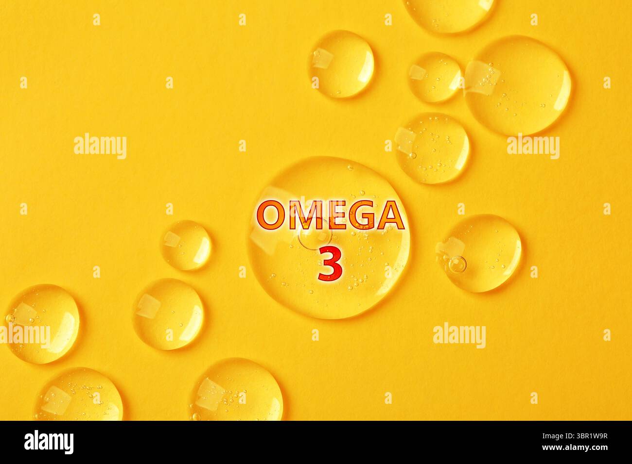 Drops of Omega-3 on yellow background, top view Stock Photo - Alamy