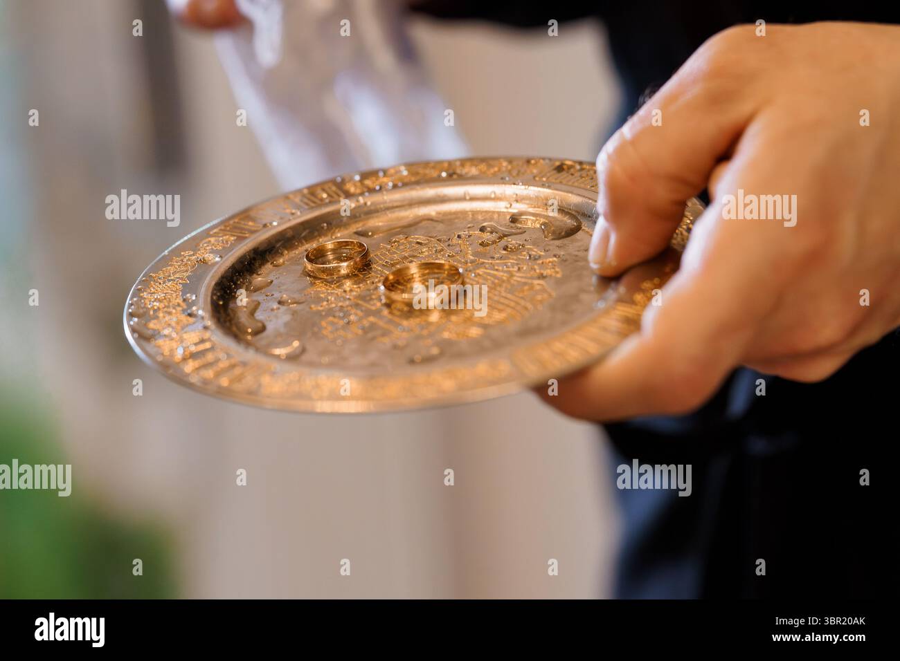 Close-up of an Orthodox Christian wedding ceremony showing a priest ...