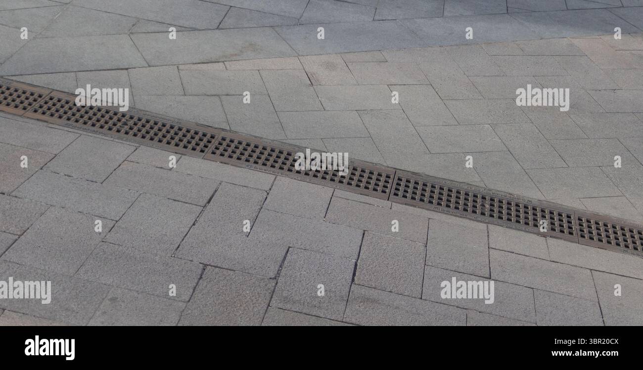 Modern urban pavement with drainage grate system Stock Photo - Alamy