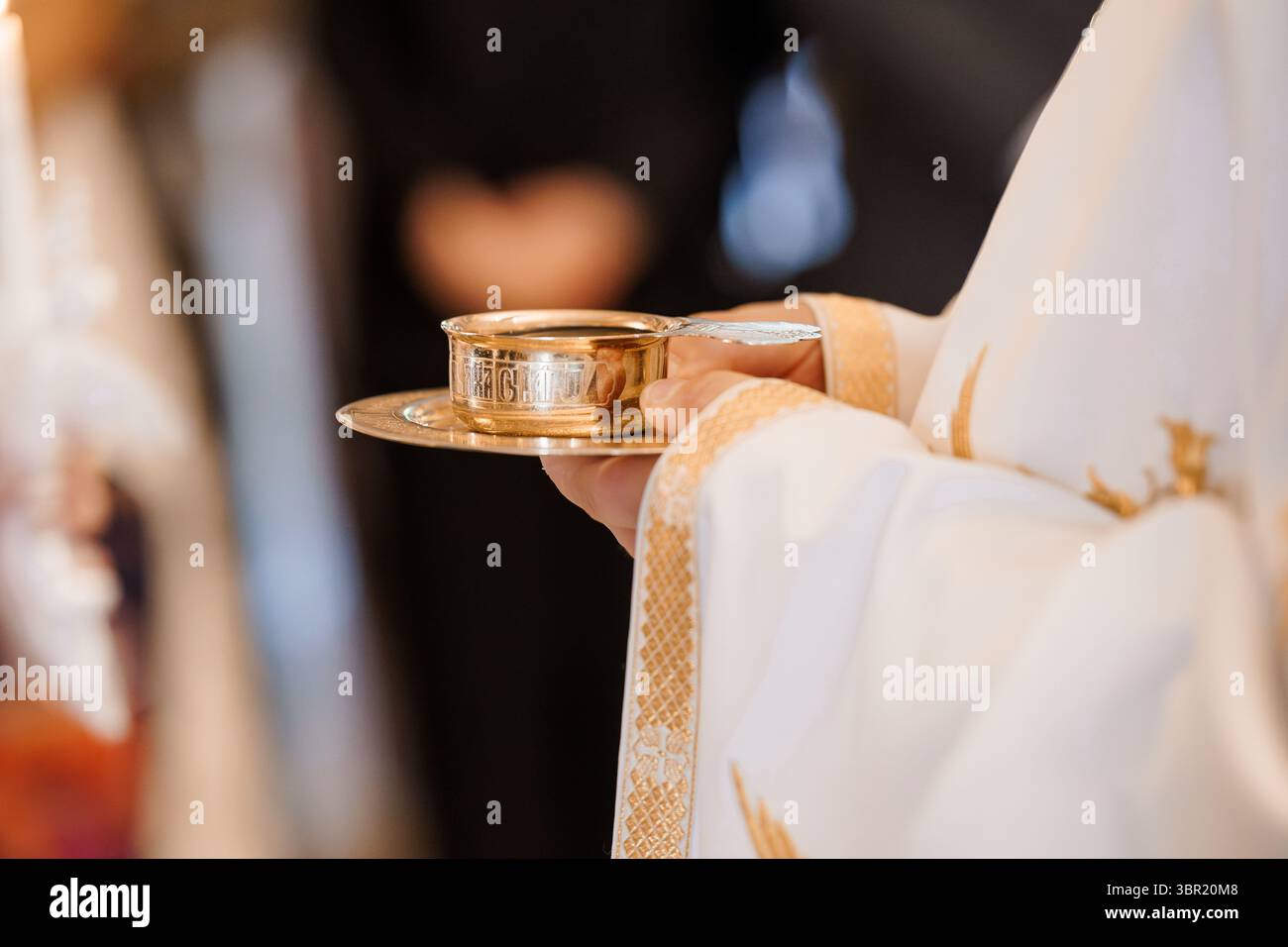 Religious scene of a priest offering the Eucharist during a Catholic ...