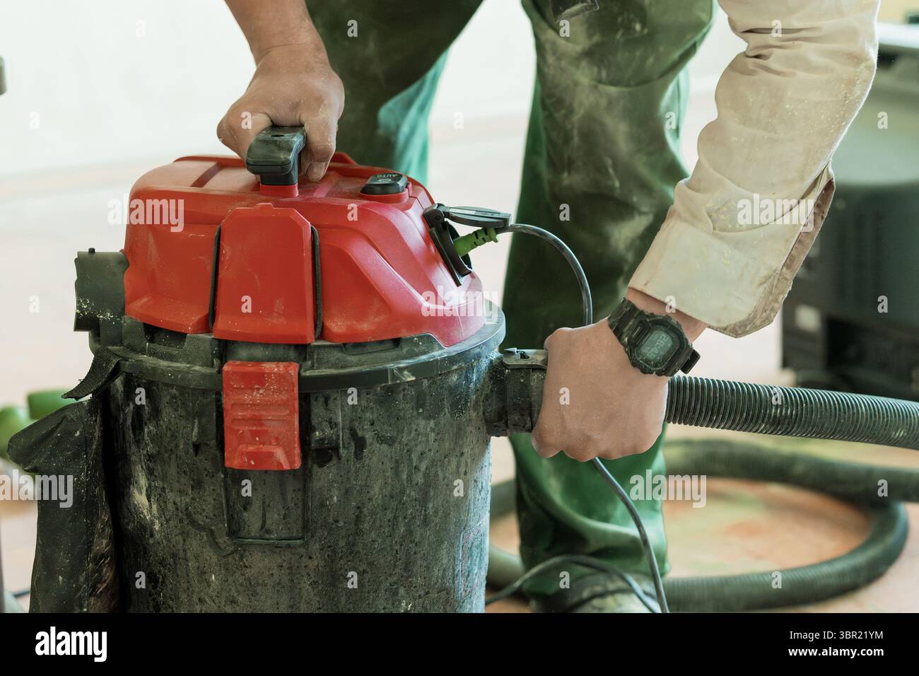 Construction Worker Using Red Industrial Vacuum Cleaner for Dust ...