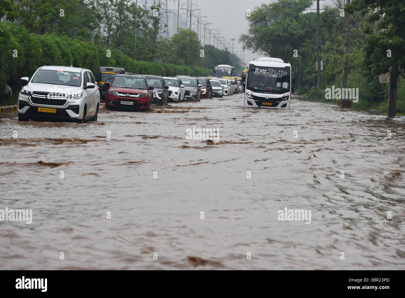 GGURUGRAM, INDIA - JULY 10: After the heavy rain vehicles wade through ...