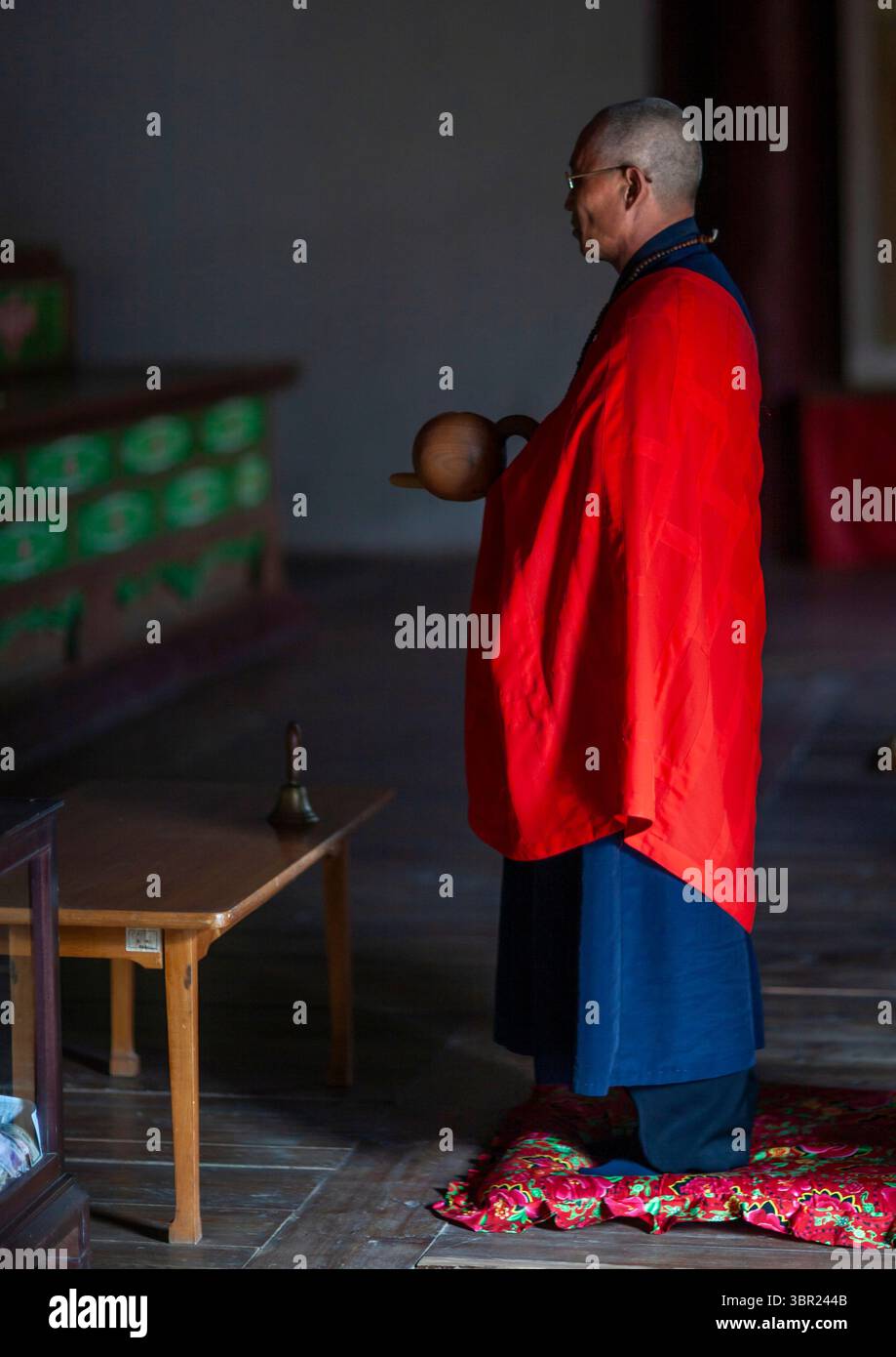 Monk praying in Pohyon-sa Korean buddhist temple, Hyangsan county ...